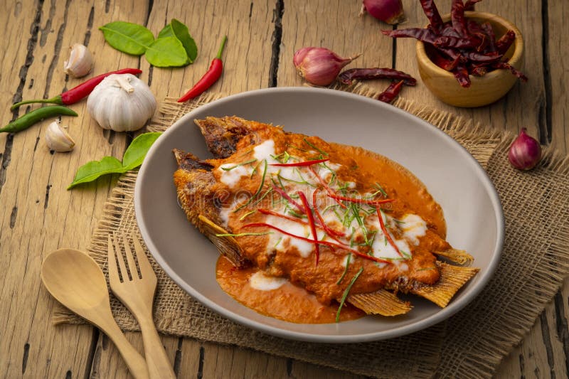 Fried Red Tilapia Fish with Red Curry Sauce in a Plate Stock Image ...