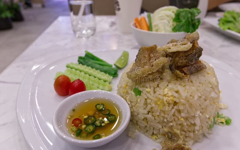 Fried Rice with Crispy Gourami Fish in White Plate Stock Photo - Image ...