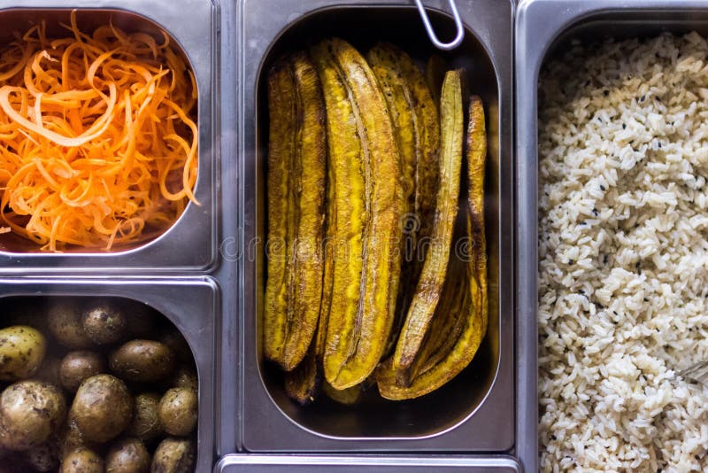 Fried Rice with Eggplants, Potatoes, and Carrots in a Cafeteria Stock ...