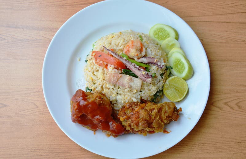 Fried Rice with Mixed Seafood and Crispy Chicken on Plate Stock Photo ...