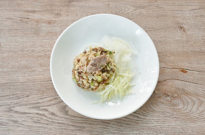 Fried Rice with Pork Topping Slice Onion and Mango on Plate Stock Photo ...