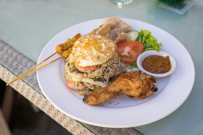 Fried Rice Served with Fried Chicken, Fried Egg and Satay Stock Image ...