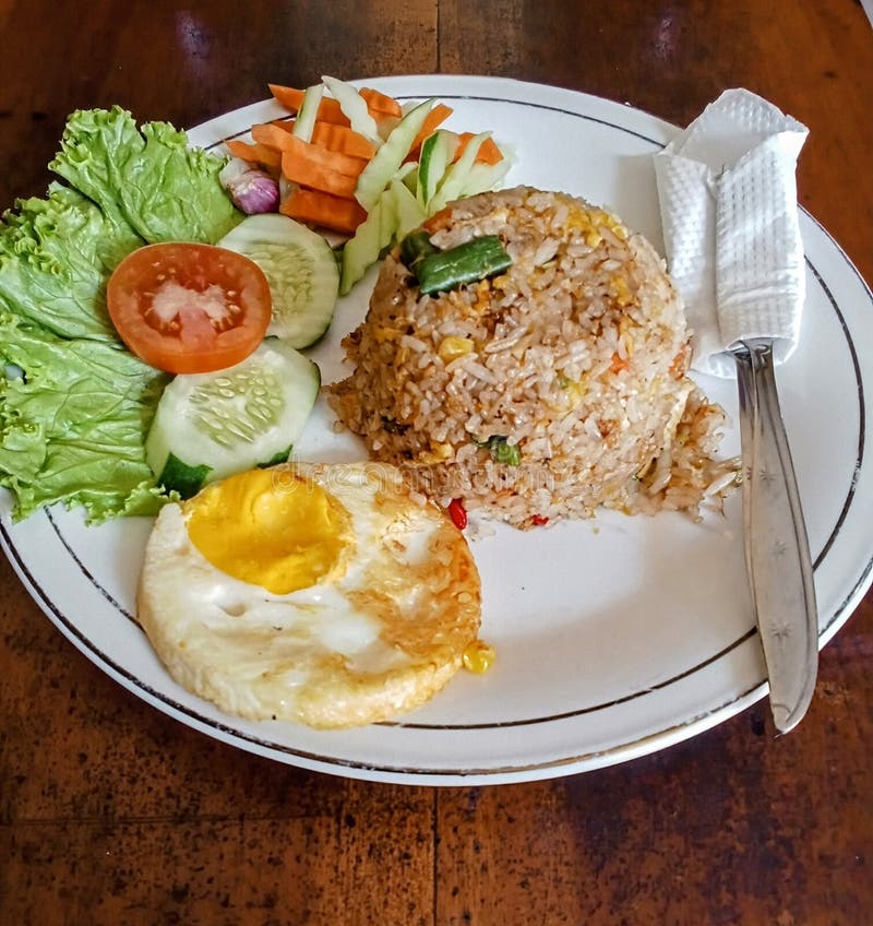 Fried Rice, Sunny Side Up Egg and Vegetables Served on One Plate Stock ...