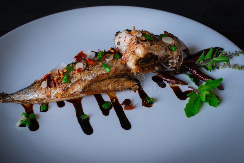 Fried Saba Fish with Sauce on White Plate and Decoration by Vegetable ...