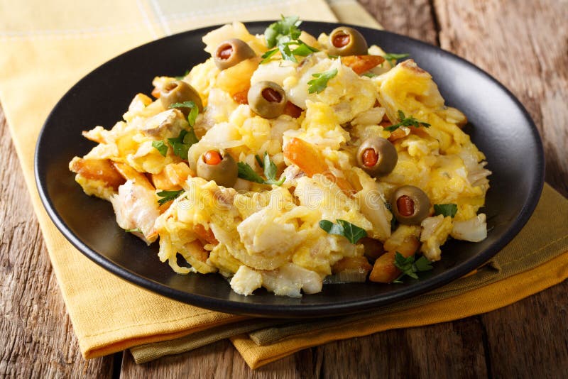Fried Shredded Cod with Potatoes, Onions, Egg and Olive on a Plate ...