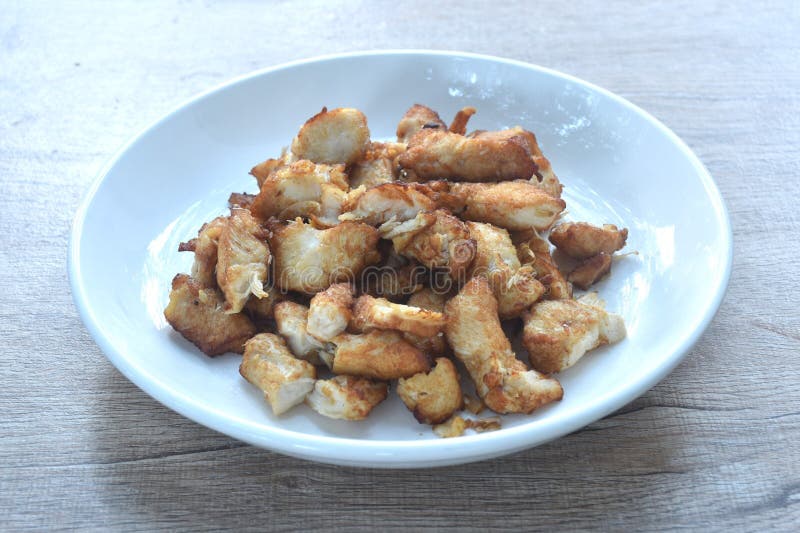 Fried Slice Chicken Meat with Salt and Garlic on Plate Stock Photo ...