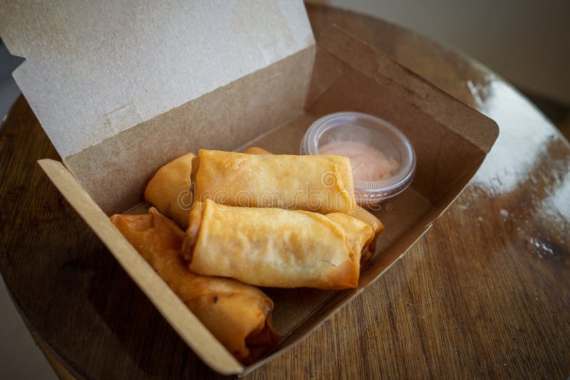 Fried Spring Rolls in a Brown Takeaway Container with Creamy Sauce ...