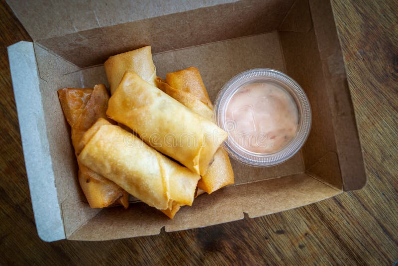 Fried Spring Rolls in a Brown Takeaway Container with Creamy Sauce ...