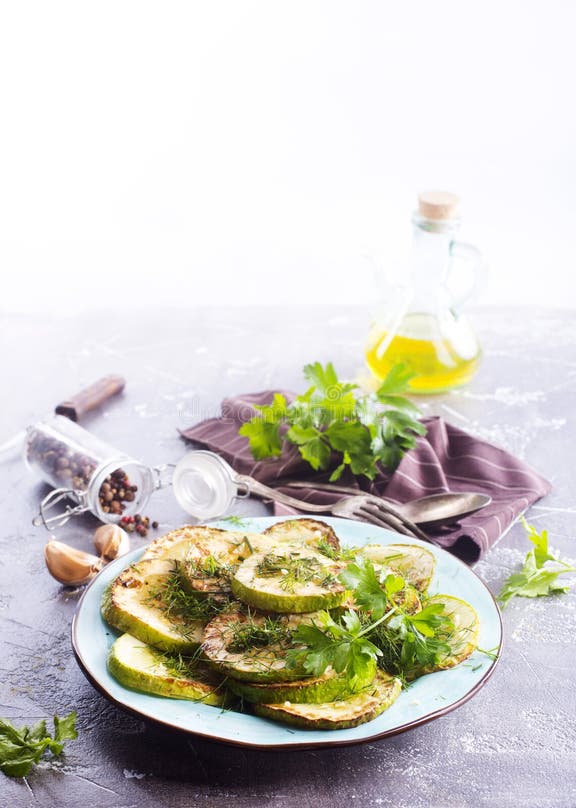 Fried Squash with Oil and Garlic on Blue Plate Stock Photo - Image of ...