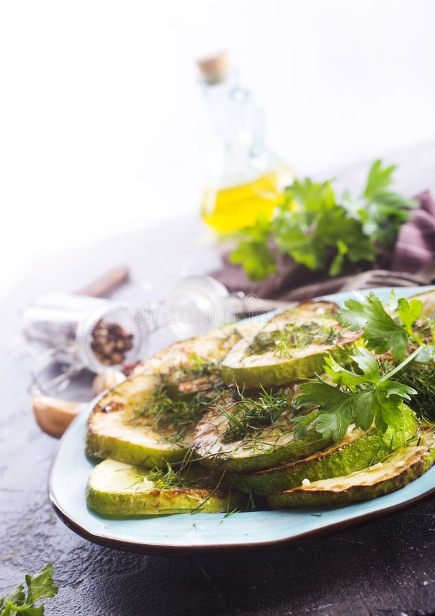 Fried Squash with Oil and Garlic on Blue Plate Stock Photo - Image of ...