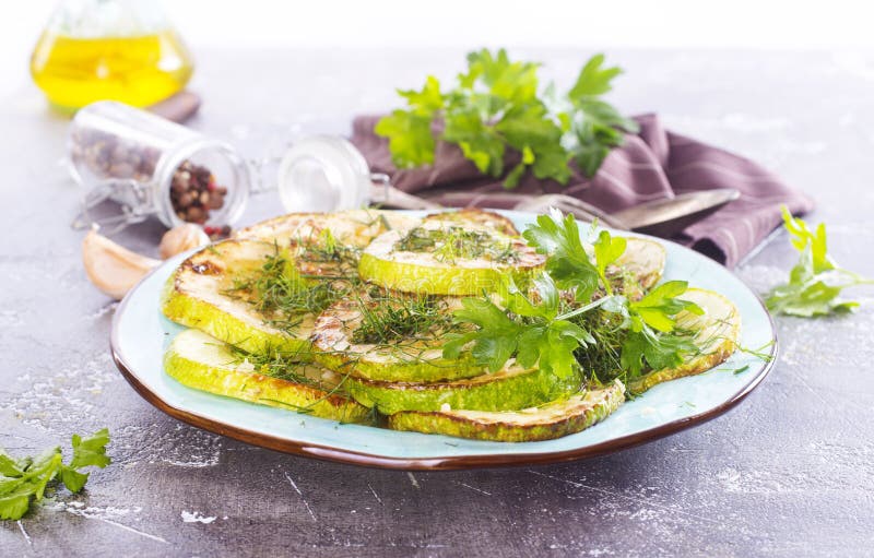 Fried Squash with Oil and Garlic on Blue Plate Stock Photo - Image of ...