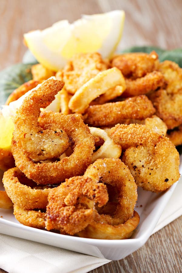 Fried Squid Rings Breaded with Lemon on a Plate Stock Photo - Image of ...