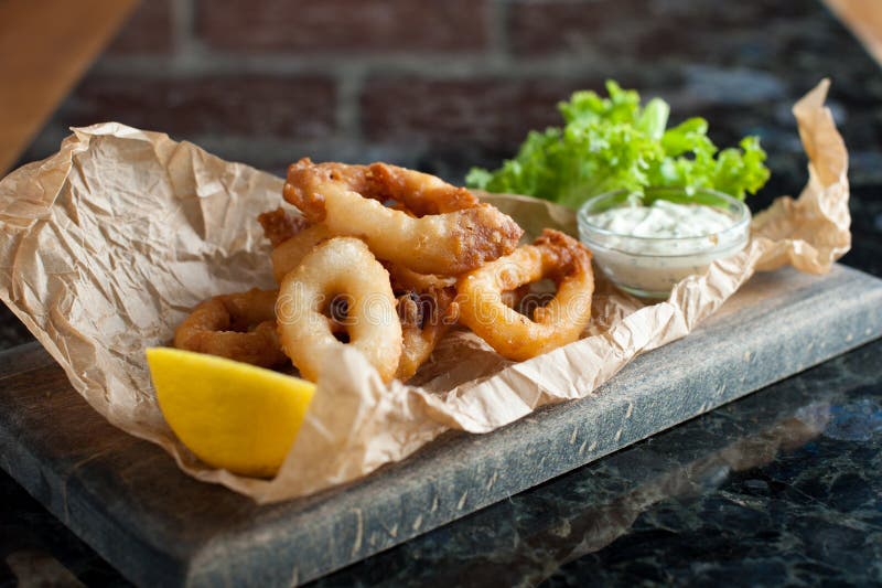 Fried Squid Rings in Breading Stock Photo - Image of serving, board ...