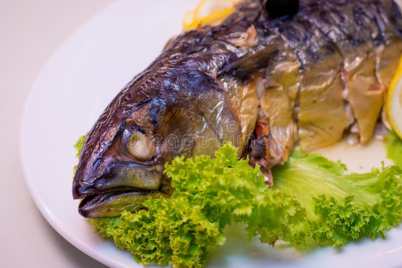 Fried Stuffed Fish at a Festive Table in the Restaurant_ Stock Photo ...