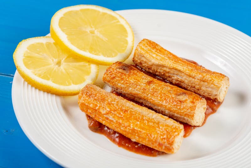 Fried Surimi Sticks with Lemons on the Blue Wooden Boards Stock Photo ...