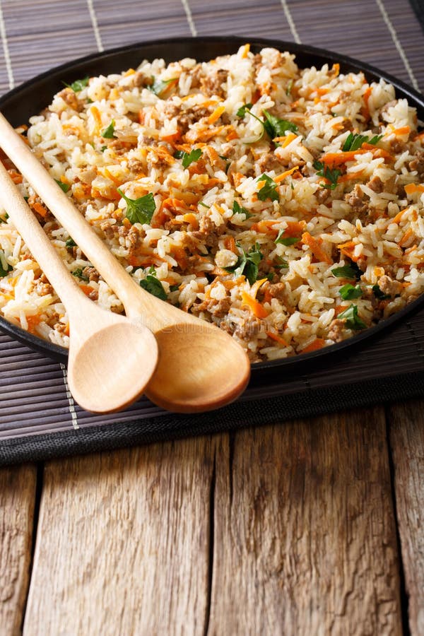 Hot Rice with Minced Meat and Carrots Close-up on a Plate. Vertical ...