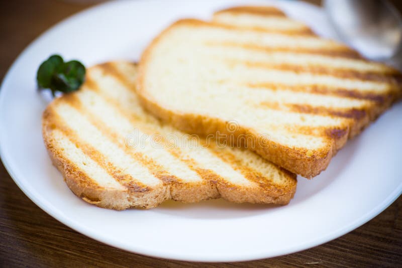 Fried Toast in a Plate on a Wooden Table Stock Image - Image of closeup ...