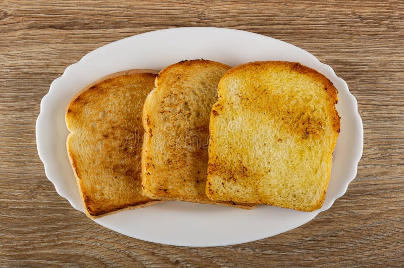 Fried Toasts in White Dish on Wooden Table. Top View Stock Photo ...