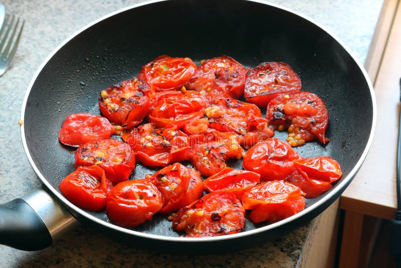 Fried Tomatoes in a pan. stock image. Image of food - 204302745