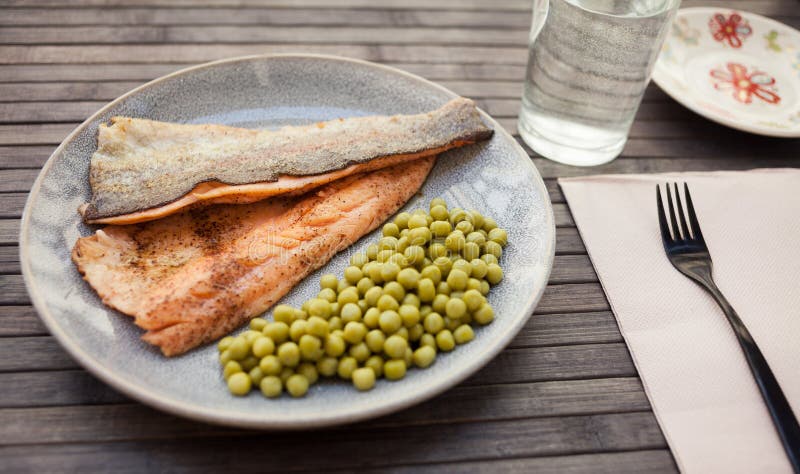 Fried Trout Fillets Served with Green Peas Stock Image - Image of ...