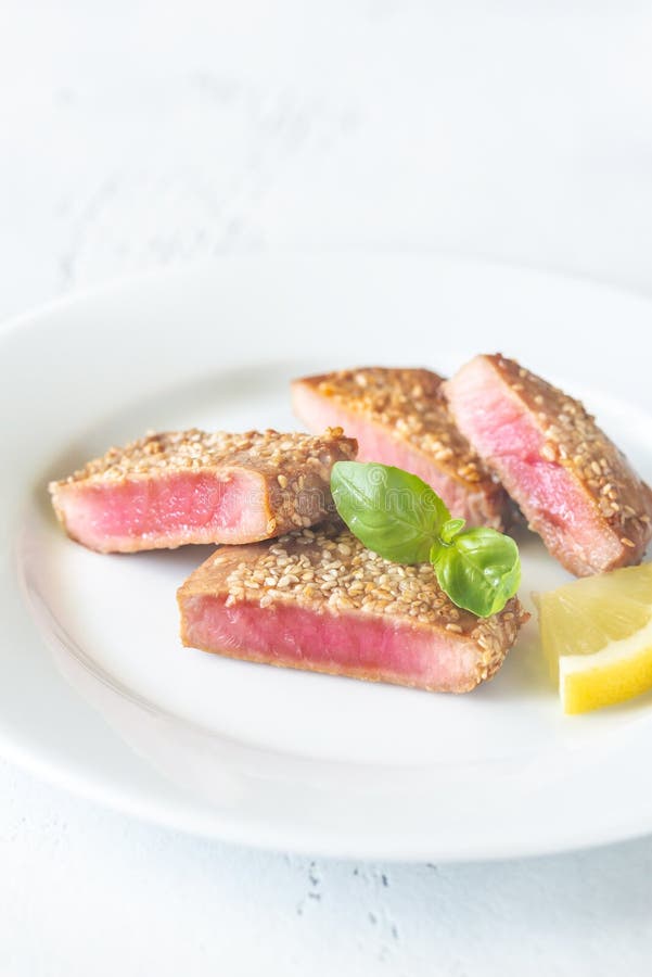Fried tuna in sesame seeds stock photo. Image of plate - 148141202
