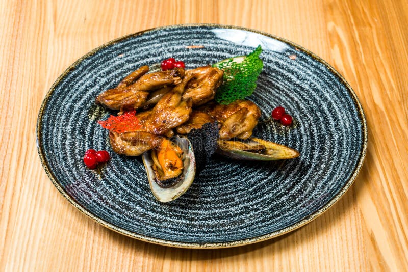 Fried Wings with Mussels in a Black Plate Stock Photo - Image of drinks ...