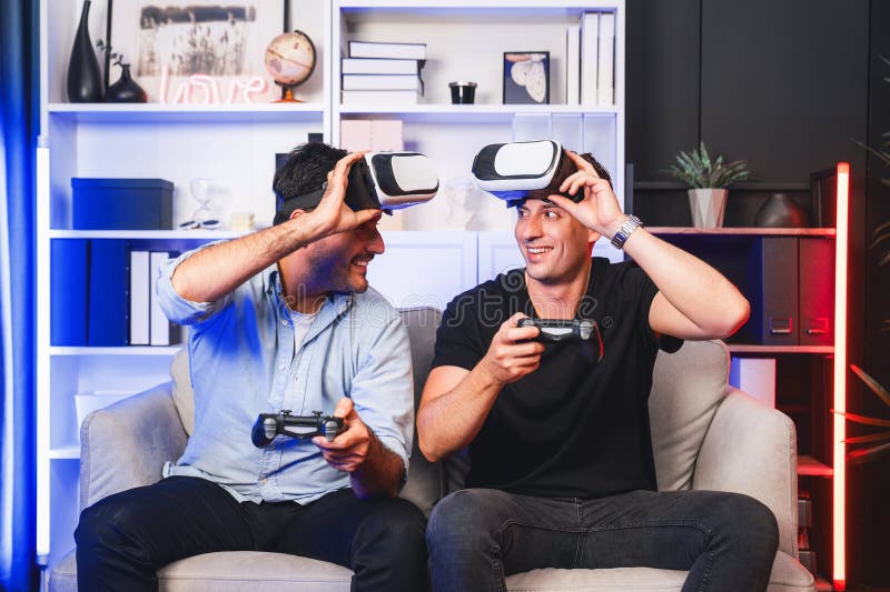 Friend Gamers Playing Video Game Using Joysticks and VR Headset ...