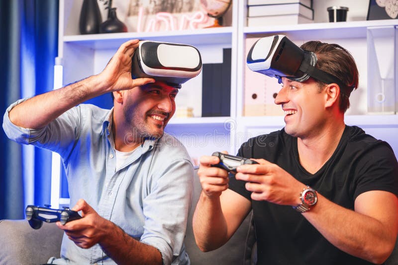 Friend Gamers Playing Video Game Using Joysticks and VR Headset ...