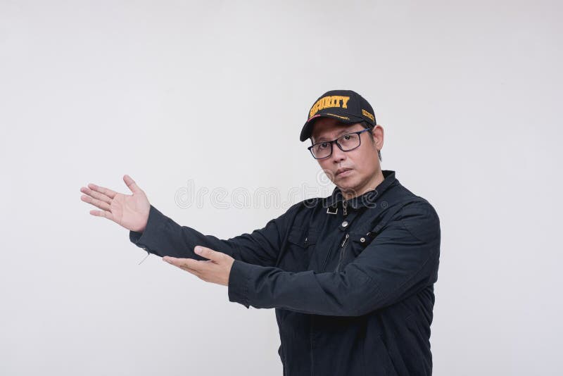 A Friendly Asian Male Security Guard Points To the Left with Both Hands ...