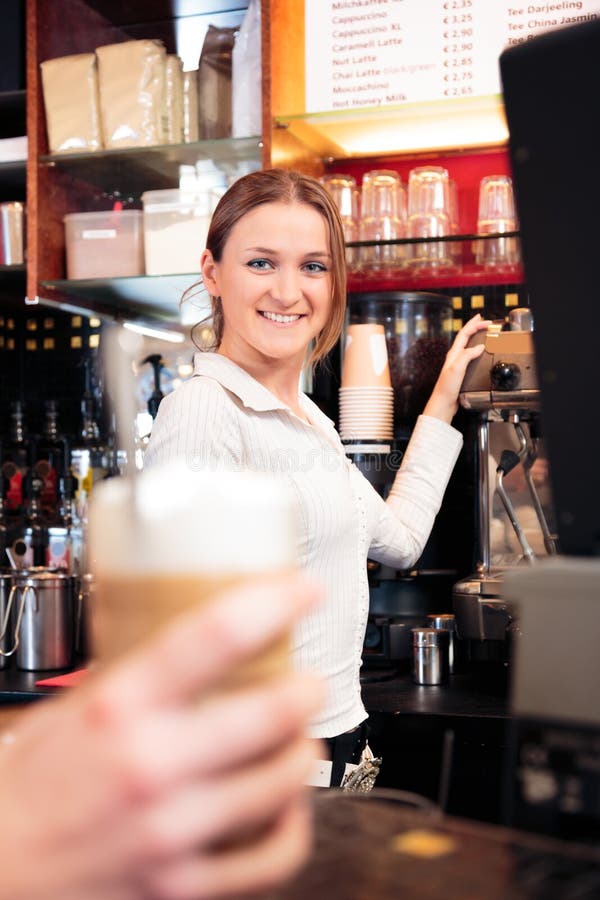 Bartender in a Cafe Grinding Fresh Coffee Beans in a Coffe Grinding ...