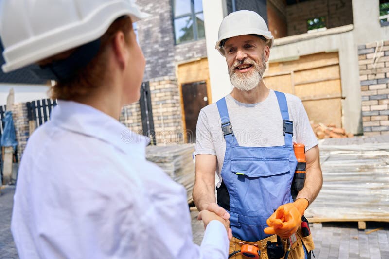 Friendly Building Contractor Greeting Site Manager with Handshake ...