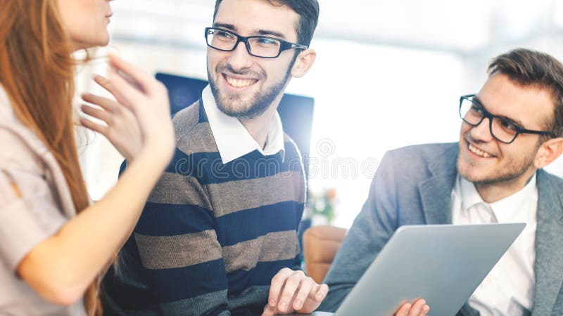 Friendly Business Team Working on Laptop and Discussing Business ...
