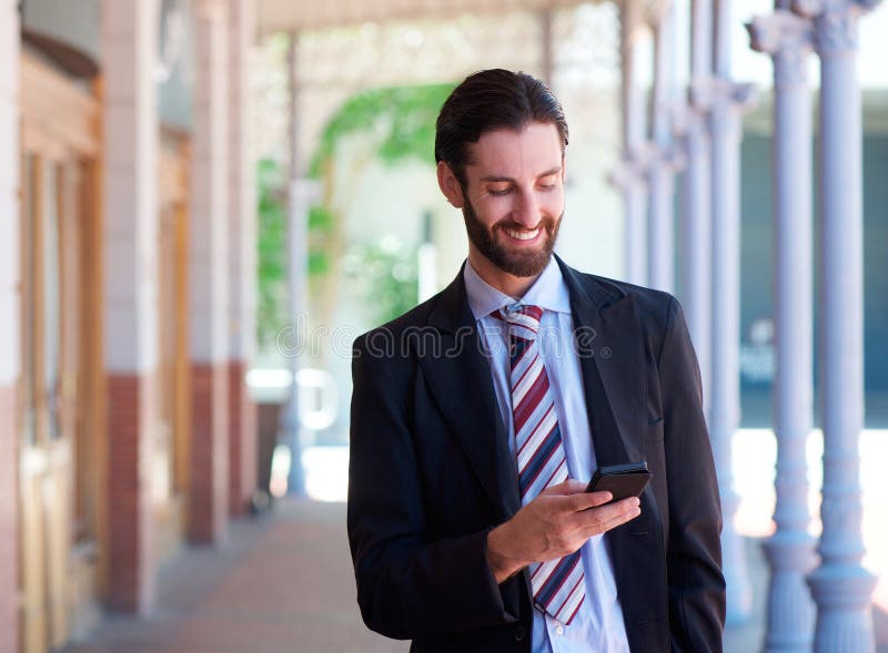 Friendly Businessman Smiling with Mobile Phone Stock Image - Image of ...