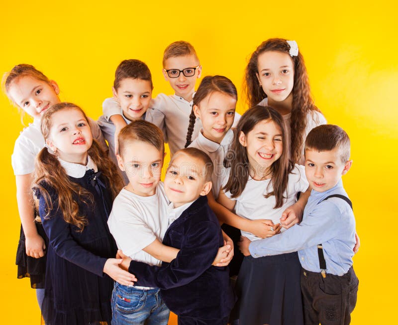 The Friendly Classmates are Hugging on a Yellow Background Stock Photo ...