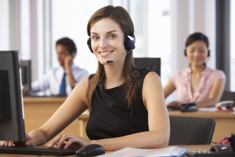 Friendly Service Agent Talking To Customer in Call Centre Stock Image ...