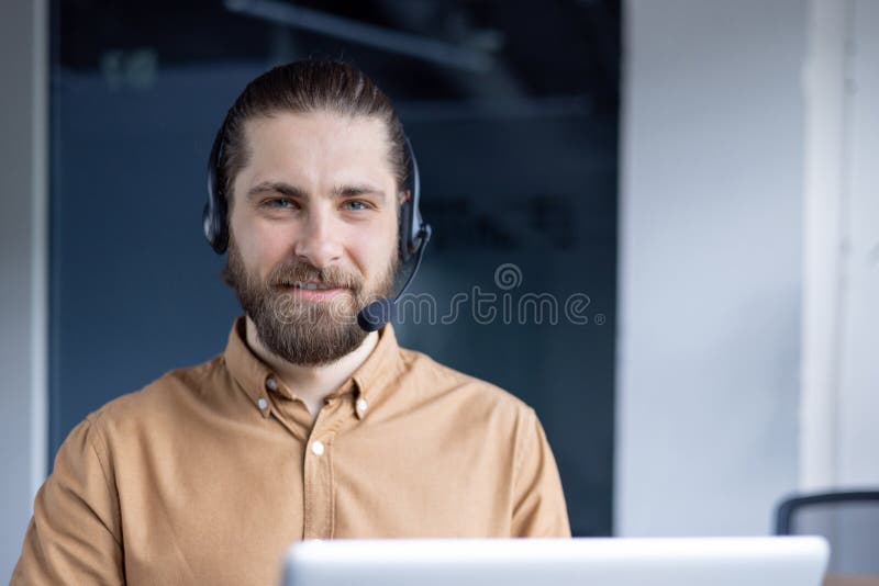 Smiling Professional Wearing Headset while Working Remotely from a ...