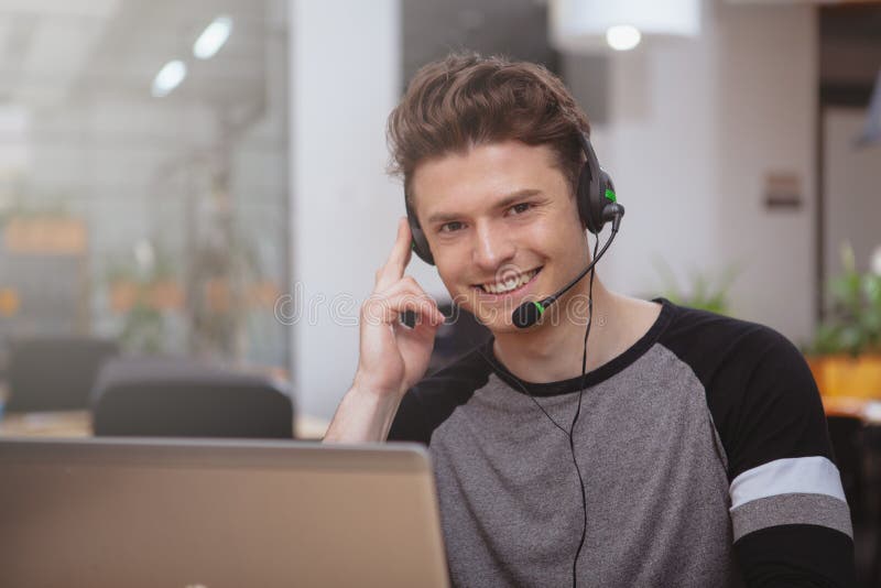 Friendly Customer Support Operator with Headset Working at Call Center ...