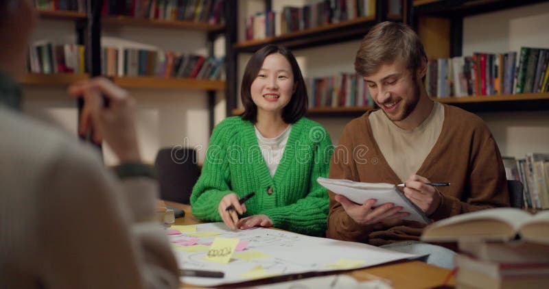 Friendly Discussion of Ideas among Students at a Table in a Cozy ...