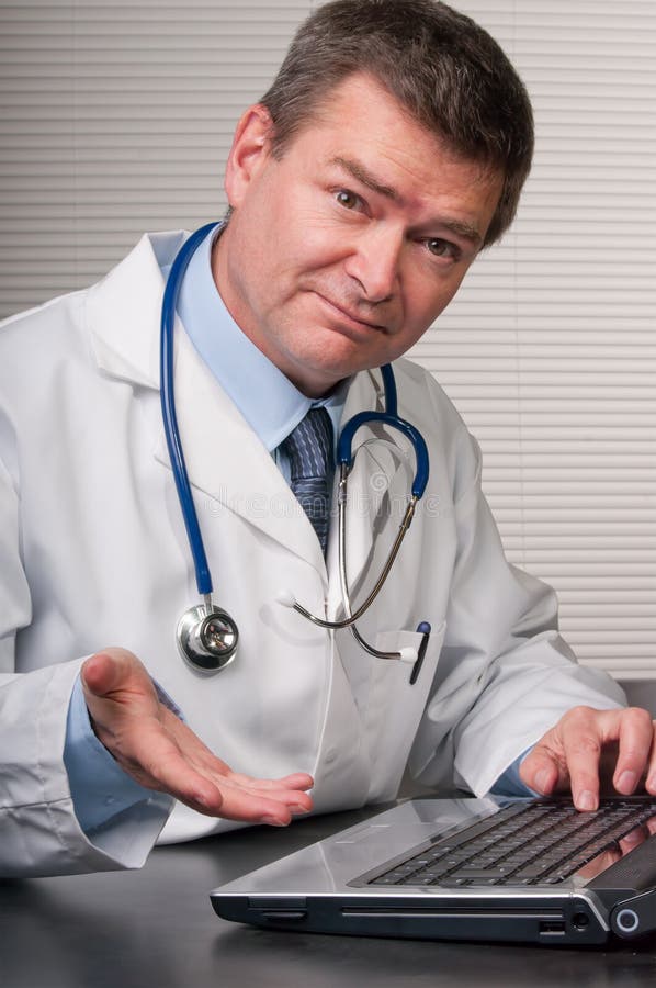 Friendly Doctor Looks at Camera and Gestures Stock Photo - Image of ...