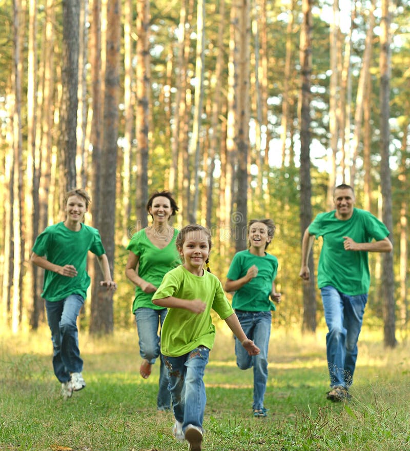 Family Running on a Dirt Road Stock Photo - Image of group, grass: 43607680