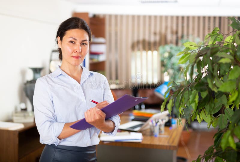 Friendly Female Administrative Secretary Standing in Office with ...