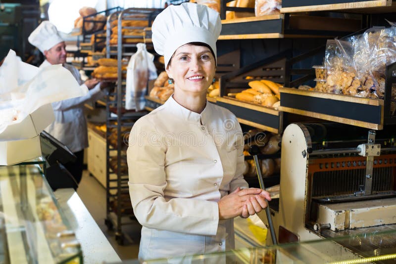 Friendly Female Baker with Fresh Bread in Bakery Stock Photo - Image of ...