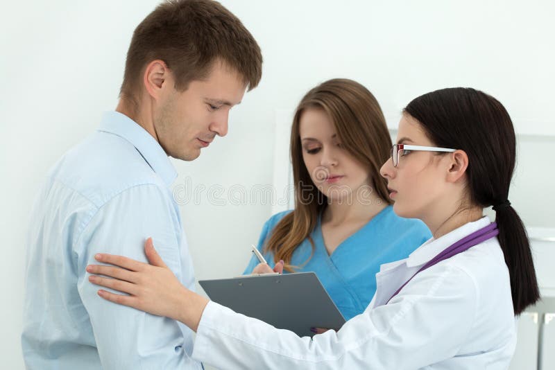 Friendly Female Doctor Touching Patient Shoulder Telling Good Ne Stock