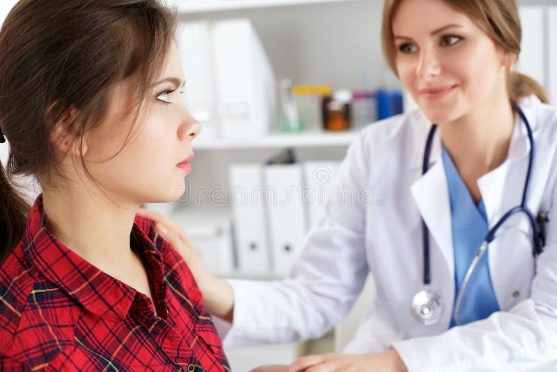 Friendly Female Doctor Touching Patient Shoulder Telling Good Ne Stock