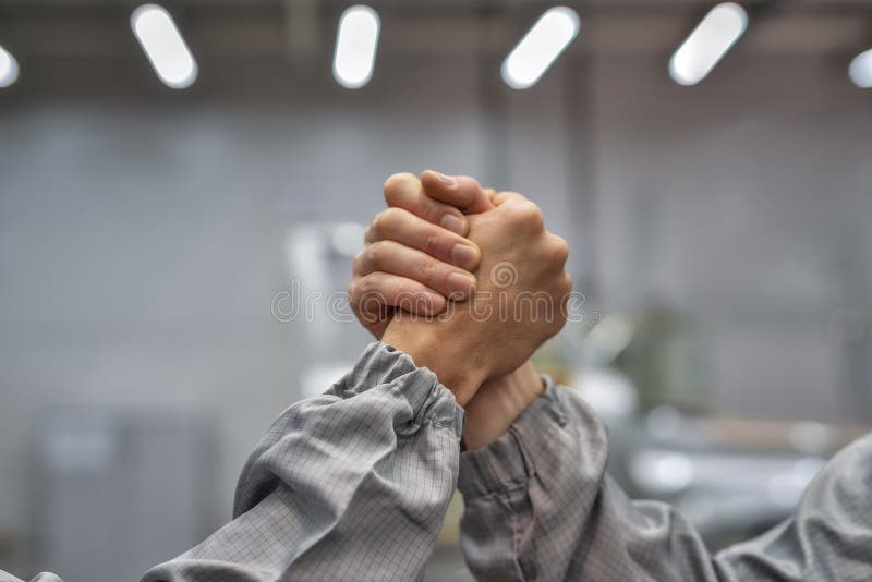 Friendly Handshake of Two Employees of the Paint Shop Stock Photo ...