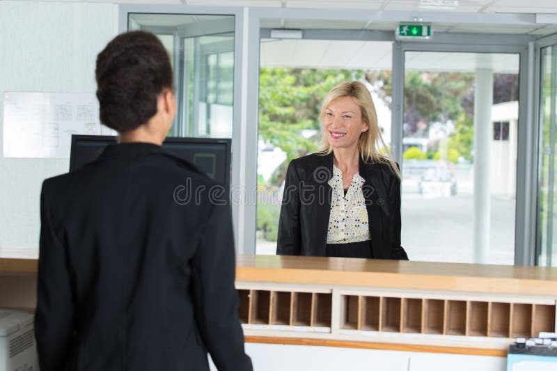 Friendly Hotel Receptionist Welcoming Female Customer Stock Photo ...