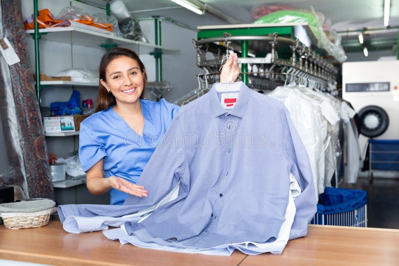 Laundry Worker Demonstrates Clean Clothes Stock Photo - Image of ...