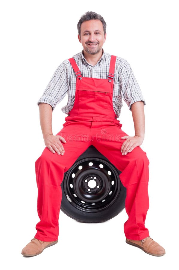 Friendly Mechanic Sitting on Car Wheel Tire Stock Image - Image of male ...