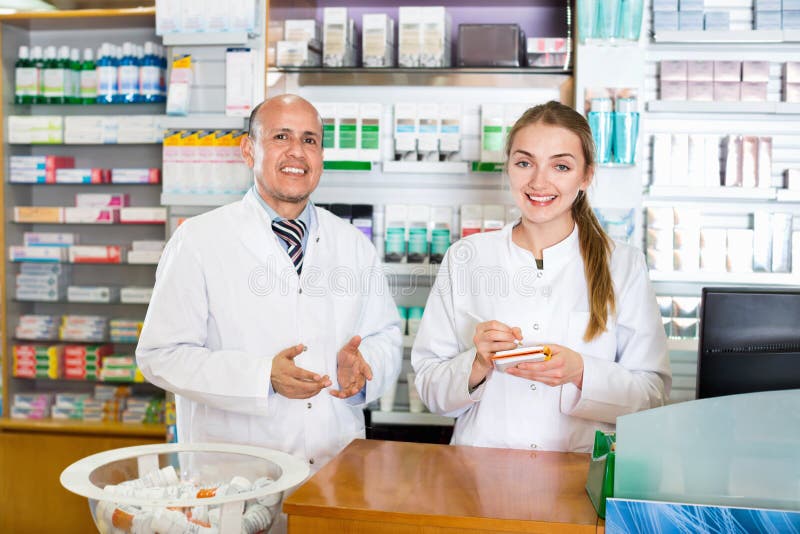 Pharmaceutists at Reception of Drugstore Ready To Help Stock Image ...