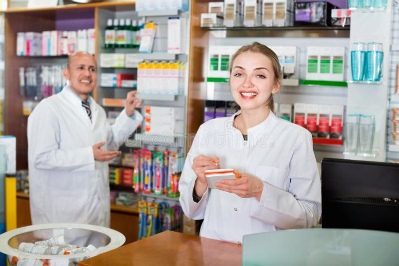 Pharmaceutists at Reception of Drugstore Ready To Help Stock Image ...